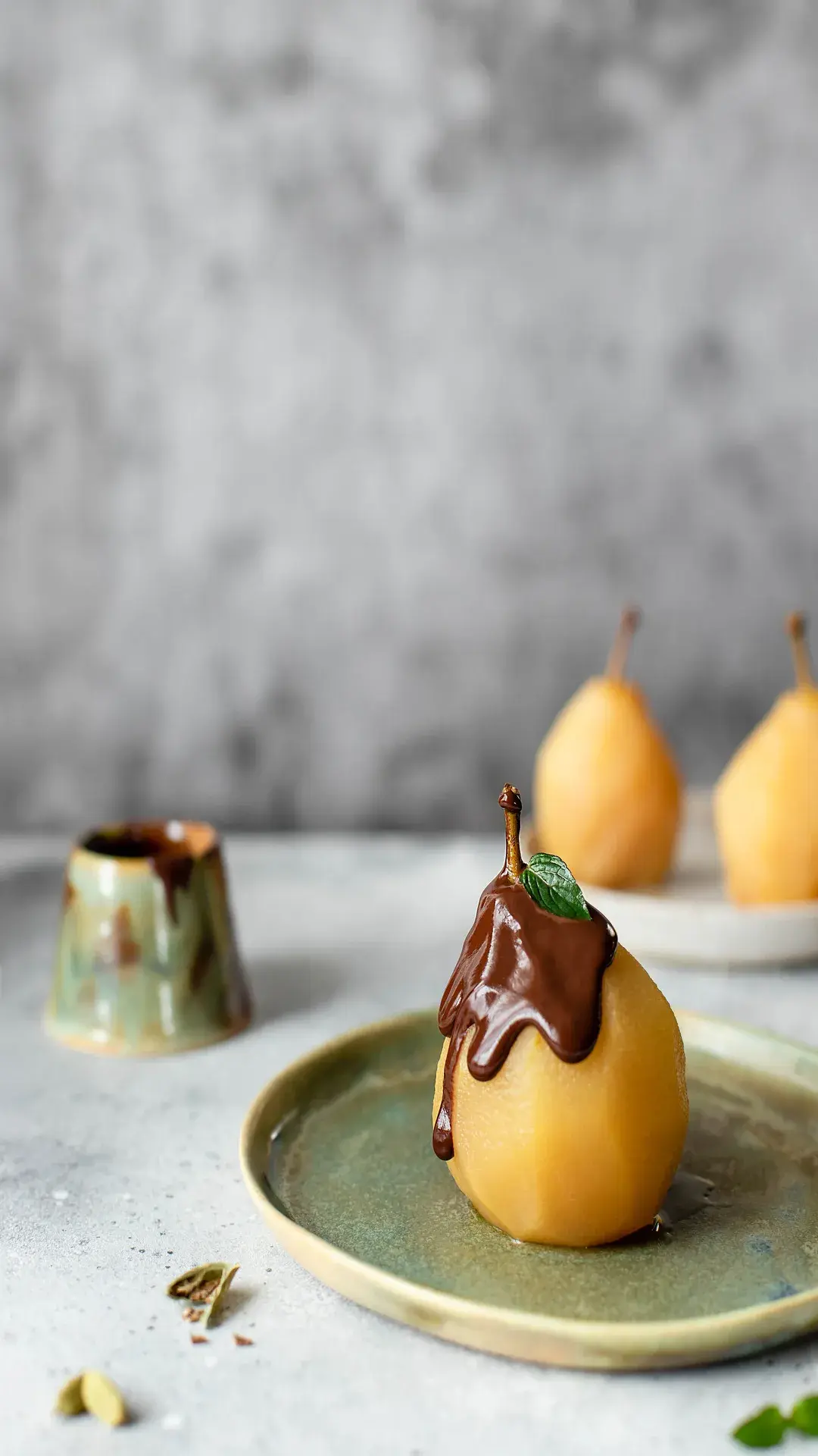 Elegant Chocolate-Poached Pears With Pistachio Crunch